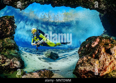 woman scuba diver by the entrance of the cave of Ginnie Springs Main ...