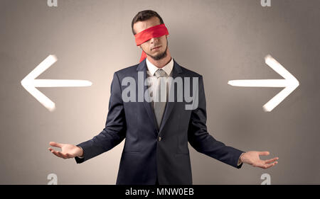 Covered eye businessman choosing between two directions Stock Photo - Alamy