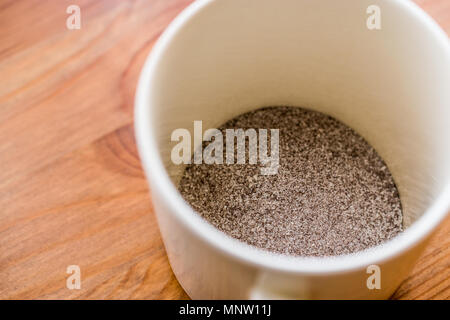 instant coffee powder 3 in 1; mixed with milk powder and sugar in a cup ...