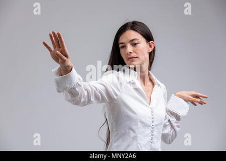 Imperious haughty woman flicking a hand in disdain Stock Photo - Alamy