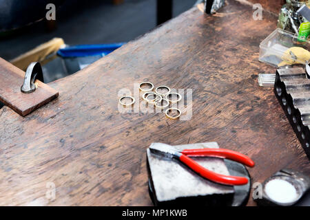 Goldsmith's bench with some golden rings in process - selectived focus ...