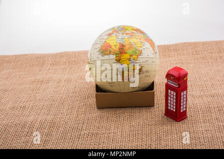 Globe with a telephone booth on canvas background Stock Photo - Alamy