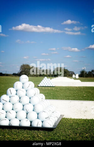 Pyramid of golf balls at a Golf driving practice range Stock Photo - Alamy