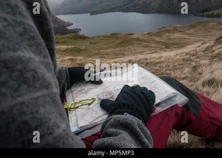 Walker using a compass and map to find way Stock Photo - Alamy
