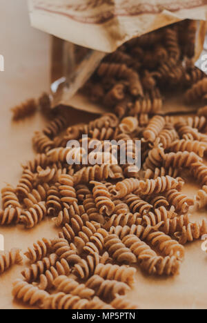 wholemeal pasta fusilli from organic whole grain spelt falling from a ...