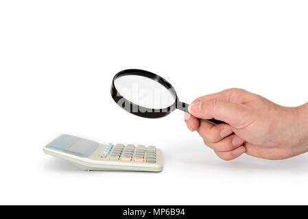 Hand with magnifying glass over a calculator, pen and money Stock Photo ...