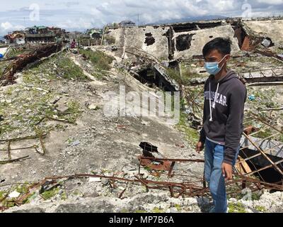 08 May 2018, Philippines, Marawi: A man sits on a pew inside the ...