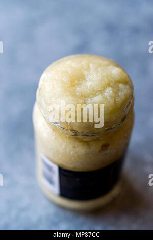 Fresh mashed Ginger puree / Adrak paste in white bowl with raw whole ...