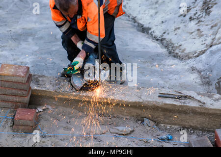 Worker uses circular saw to cut wooden beams in backyard during ...