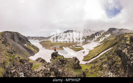 man standing on volcanic slag with view on snowy volcanoes Stock Photo ...