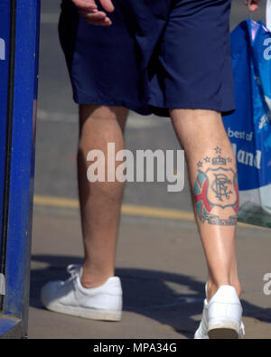 portrait of a male football fan standing on the stadium while ...
