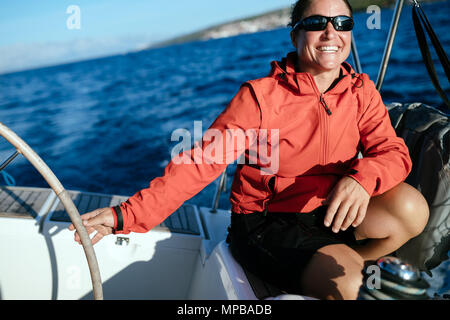 Attractive strong woman sailing with her boat Stock Photo - Alamy