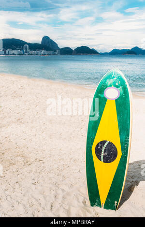 Brazilian flag stand up paddle surfboard standing on the beach at ...