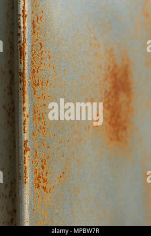 Weathered silver painted steel rusting with streaks of rust caused by ...