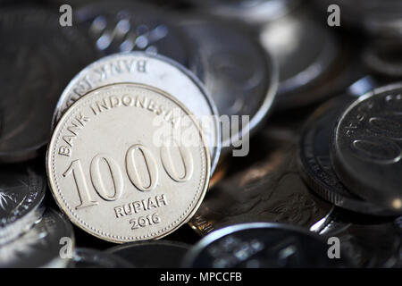 Stack of Indonesian Rupiah currency coins on a gray background with ...