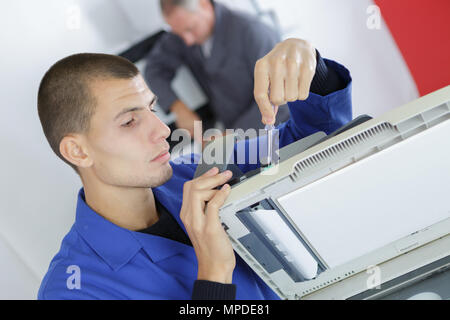 a repairman disassembling computer unit Stock Photo - Alamy