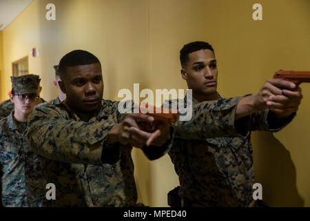 Marines demonstrate proper room-clearing techniques for members of the ...