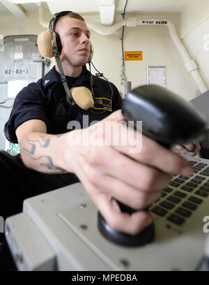 A U.S. Navy Fire Controlman operates a long-range acoustic device ...