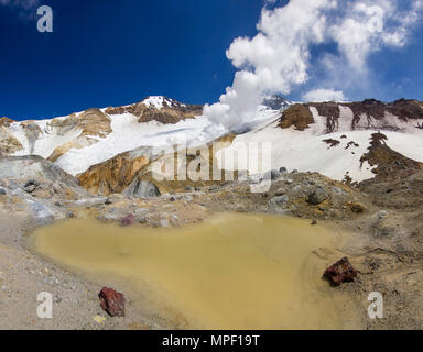steaming crater of active volcano covered by snow Stock Photo - Alamy