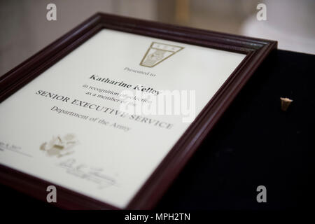 The Senior Executive Service certificate and SES pin is in place before ...