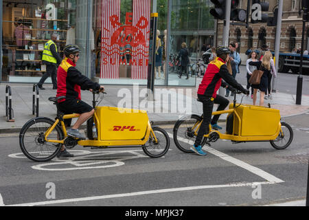 DHL courier delivering packages with his yellow van in Saumur, Loire ...
