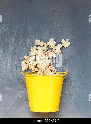 Full popcorn bucket on a dark background Stock Photo - Alamy