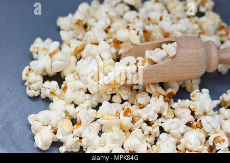 A lot of popcorn and a small wooden spatula Stock Photo - Alamy