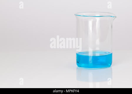 Glass beaker of copper sulfate solution (copper chloride) blue liquid ...