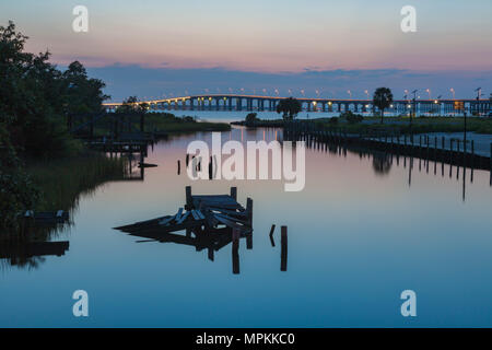 St. Louis Bay Bridge behind the remains of an old wooden dock in a ...