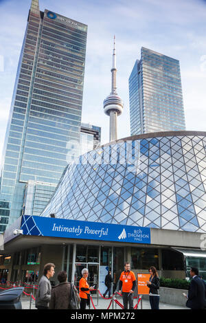 A worker at Roy Thomson Hall in Toronto prepares to unroll the red ...