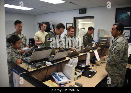 Members of the 144th Maintenance Operations Flight debrief 194th ...