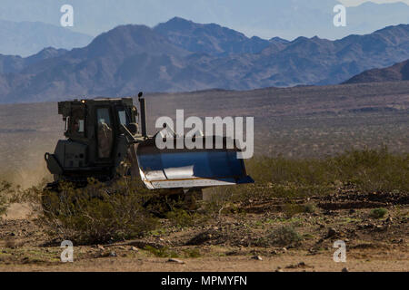 A dozer drives across a forward arming and refueling point during ...