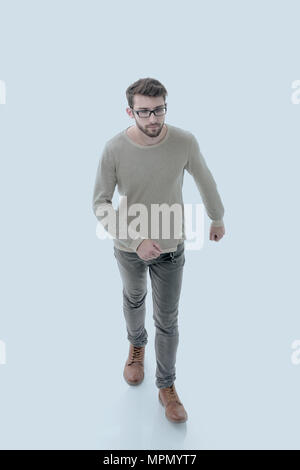 modern young man confidently goes forward. Photo in full length Stock ...