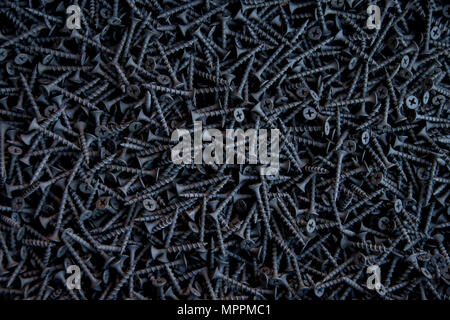 lot of short metal screws macro Stock Photo - Alamy