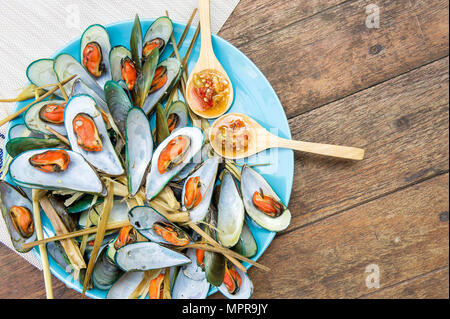 Steaming mussel With delicious sauce on dish with wood table seafood ...