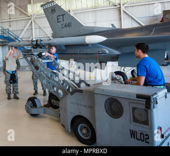 The 96th Aircraft Maintenance Squadron Blue Crew loads an AIM-120 onto ...
