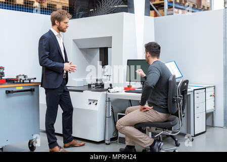 Businessmen and engineers talking in the factory Stock Photo - Alamy