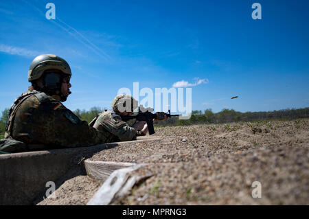 A German air force airman fires an M4A1 carbine during Combat Arms ...