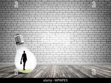 Businesswoman trapped in bulb Stock Photo - Alamy