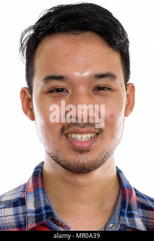 Face of young happy Asian man smiling against white background Stock ...