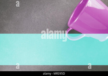 magenta tea cup on a rough dark stone surface - directly above view ...