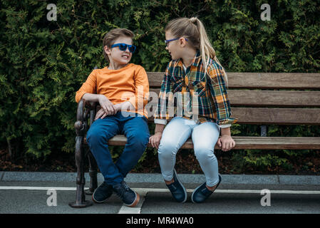 kids fashion. funny boy in blue and black sweatshirt and jacket, cap ...