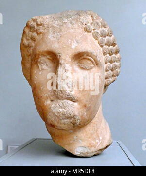 Head from a colossal statue of a woman wearing a sakkos (cap). Parían ...