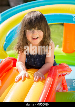 Toddler playing in garden Stock Photo - Alamy