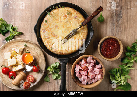 Fried Egg with ingredients in cast iron frying pan, on white background ...