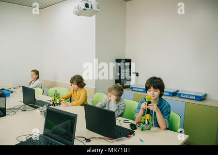 Group of focused kids working at class Stock Photo - Alamy