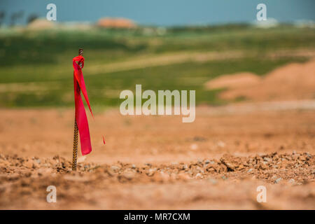 Metal survey peg with red flag on construction site Stock Photo - Alamy
