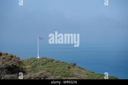 Union flag and flagpole on headland against blue sky Stock Photo - Alamy