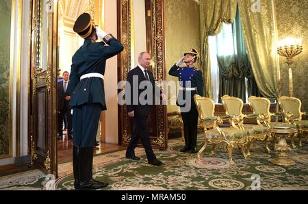 Russian President Vladimir Putin is saluted by Kremlin Guards as he ...