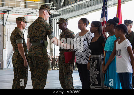 Sgt. Maj. Joseph O. Richardson (left) prepares to pin Maj. Michael C ...
